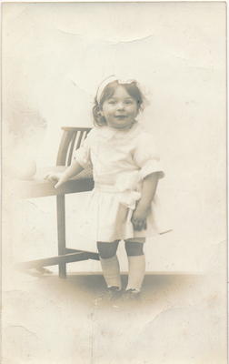 Child standing next to chair - Centre for Gold Rush Collections